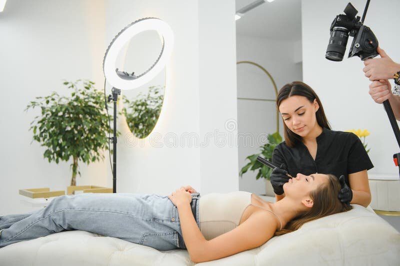 Cosmetologist Doing Permanent Makeup Eyebrows. Care and Beauty Concept ...