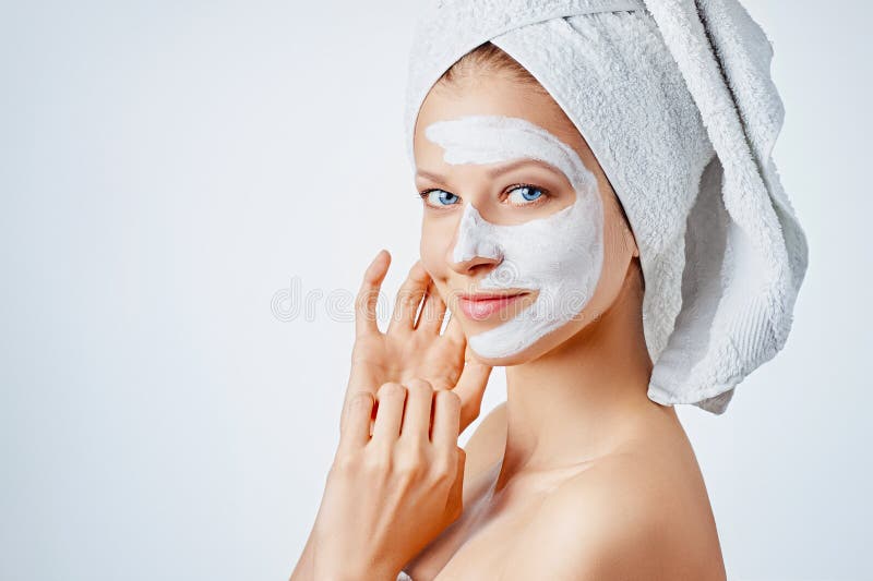 Beautiful Woman Applying Facial Mask On Her Face Skin Care And