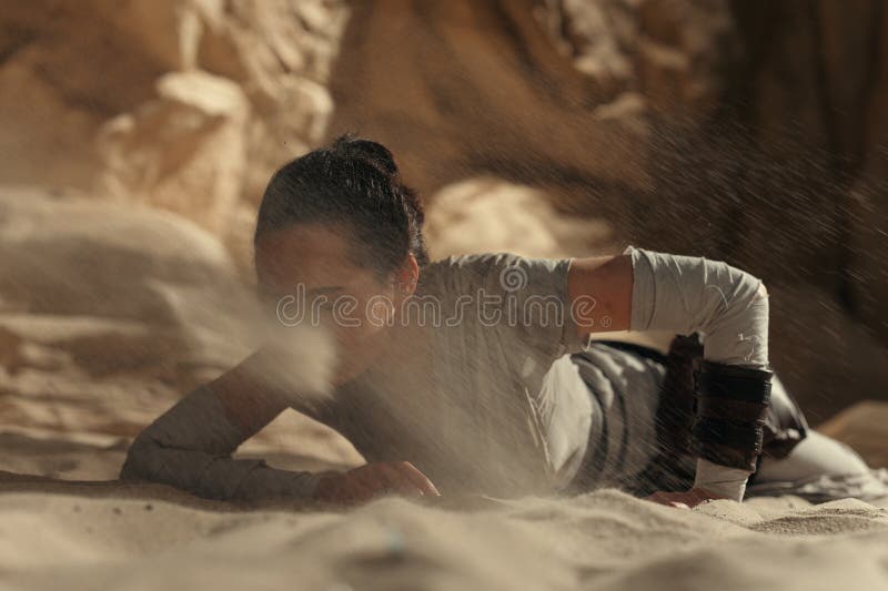 Cosplayer Girl Portrays Character Rey Skywalker From The Star Wars Universe And Lies Down In