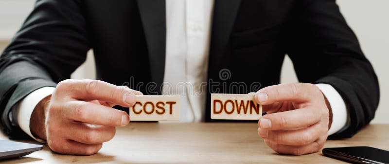 Cost Down Concept. Man Holds Wooden Blocks with Inscriptions Cost Down ...