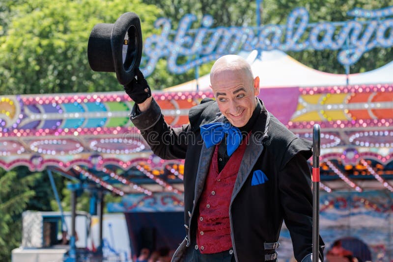 Costumed Carnival Performer on Stilts Welcomes the Crowd in an ... Costumed Carnival Performer on Stilts Welcomes the Crowd in an ...