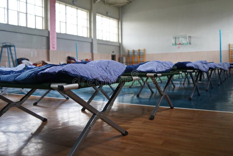 Cots with Sleeping Bags are Placed in the School Gym during an ...