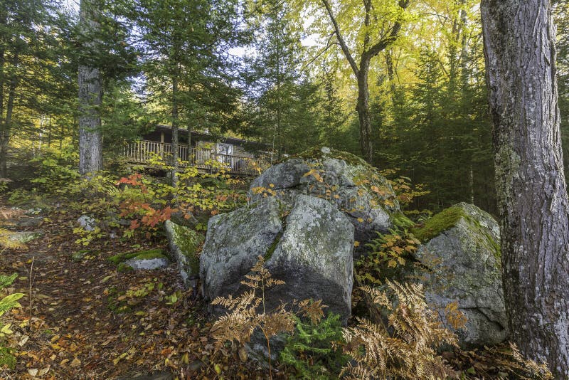 Cottage in Autumn with Large Rocks in the Foreground Stock Photo ...