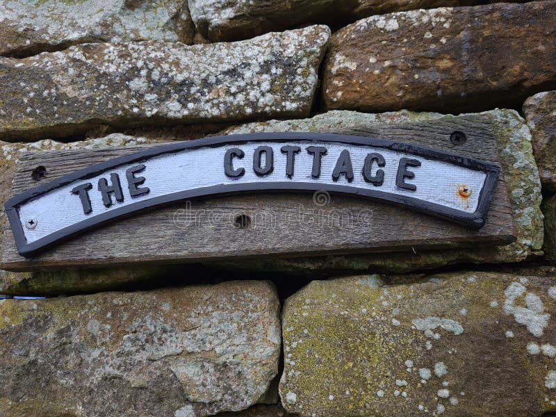 The Cottage Sign Against a Brick Wall Stock Image - Image of soil ...