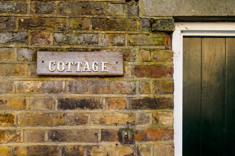Cottage Wooden Sign on a Brick Wall. Stock Photo - Image of decoration ...