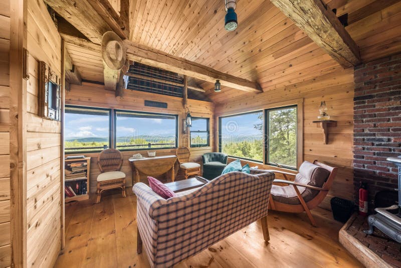 Couch Facing Big Windows in a Rustic Living Room with Wooden Beams on ...