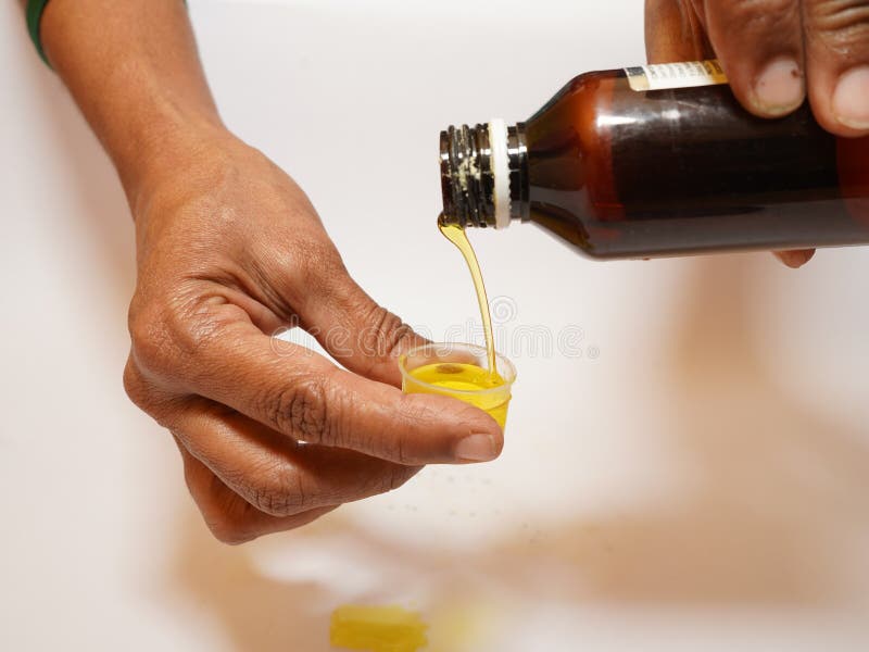 Cough Syrup or Cold Medicine Poured into the Cup Stock Photo - Image of ...