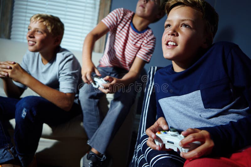 We Could Play All Night. Young Boys Playing Video Games. Stock Photo ...