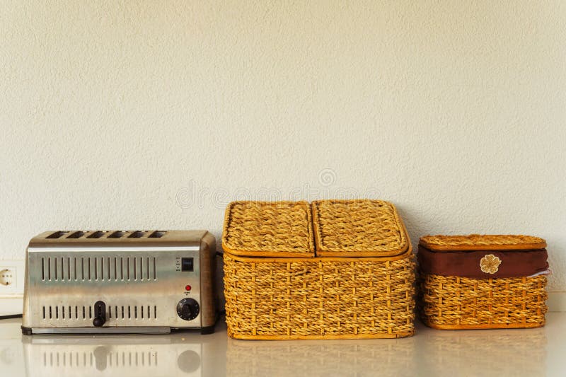 On the Counter, There is a Toaster Alongside Two Baskets that Sit Stock ...