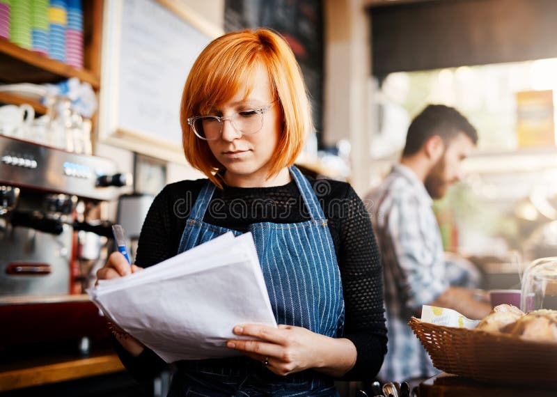 Counting Her Stock. a Shop Owner Doing Some Paperwork. Stock Photo ...