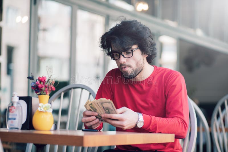 Counting money in a cafe stock photo. Image of dollar - 216549704