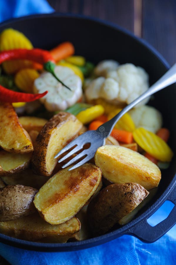 Country Baked Potatoes with Vegetables in a Roasting Pan Stock Photo ...