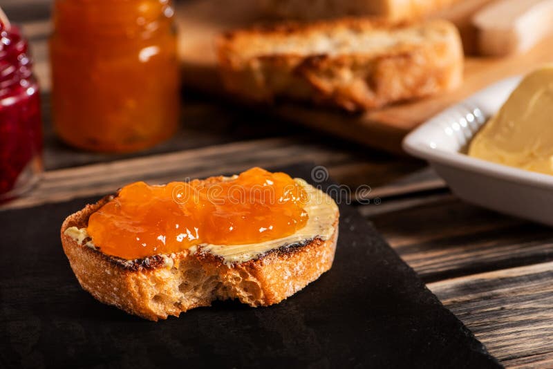 Country Bread Toast with Butter and Peach Jam, Close-up Stock Photo ...