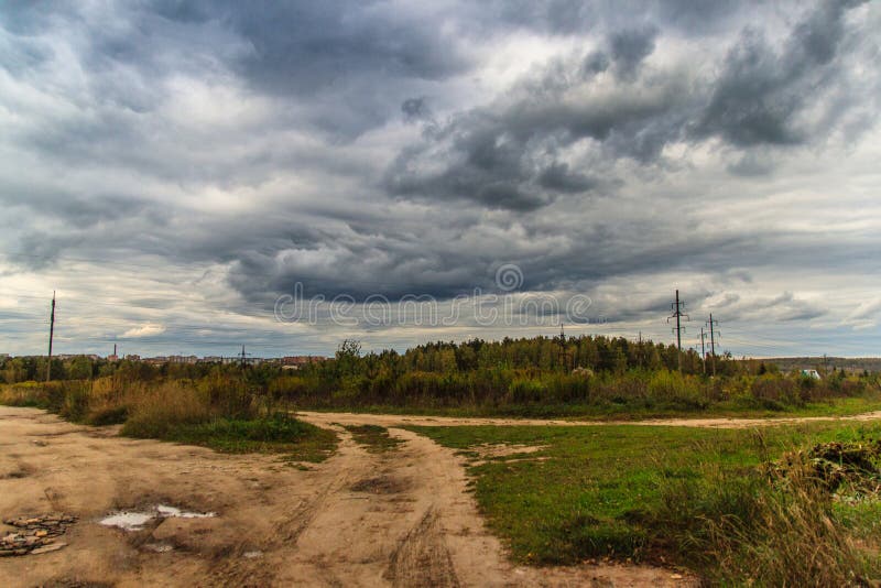 Country Landscape with Cloudy Stormy Sky and a Field and a Forest in ...