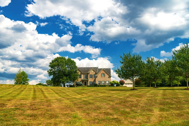 Country Luxury Brick House with Large Lawn Under Blue Clouds Stock ...