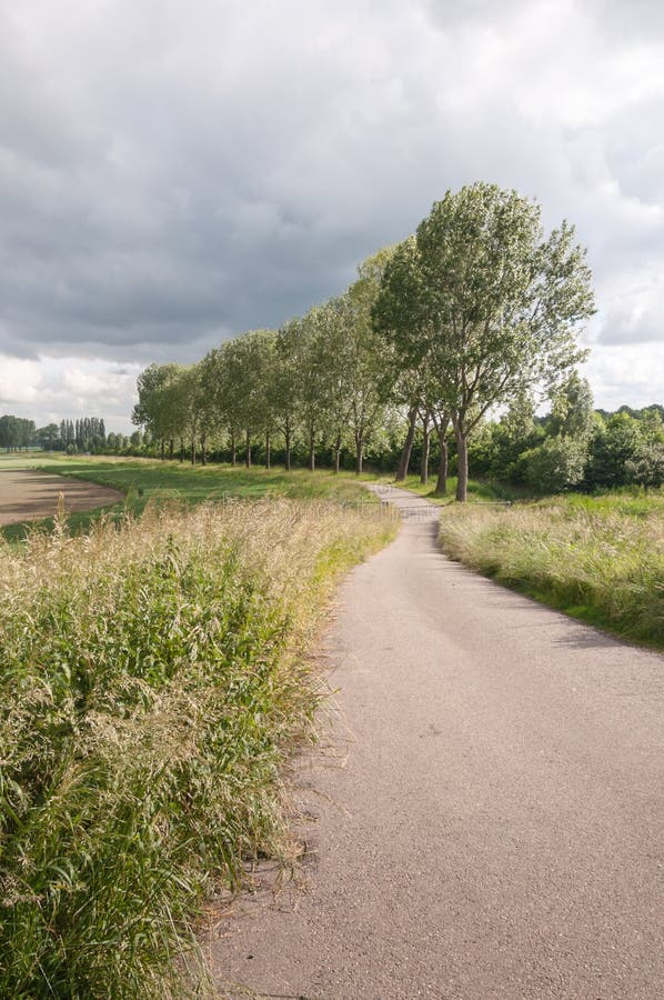 Country Path in a Rural Landscape with Threatening Clouds Stock Photo ...