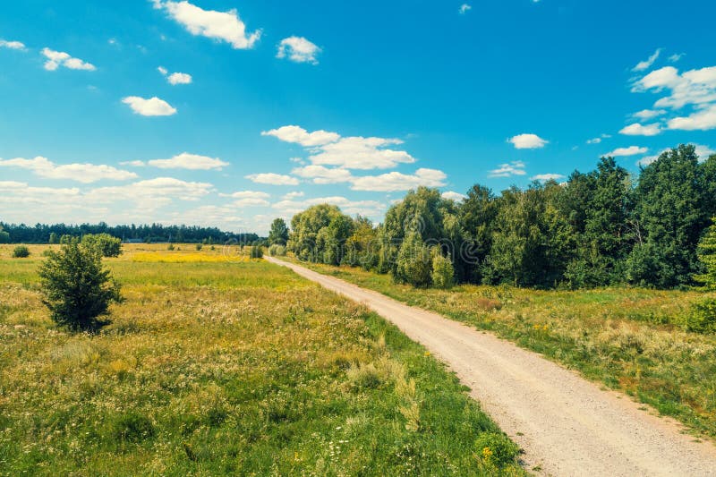 A Country Road Along the Field at Sunset Stock Photo - Image of evening ...
