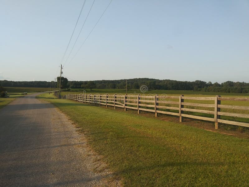 Country road with a fence stock photo. Image of country - 196135532