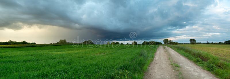 Country Road through Green Fields and Rainy Cloud Stock Image - Image ...