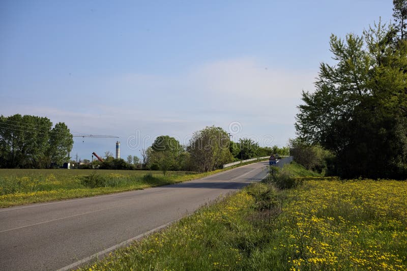 Country Road Next To Fields and Houses in Springtime Stock Photo ...