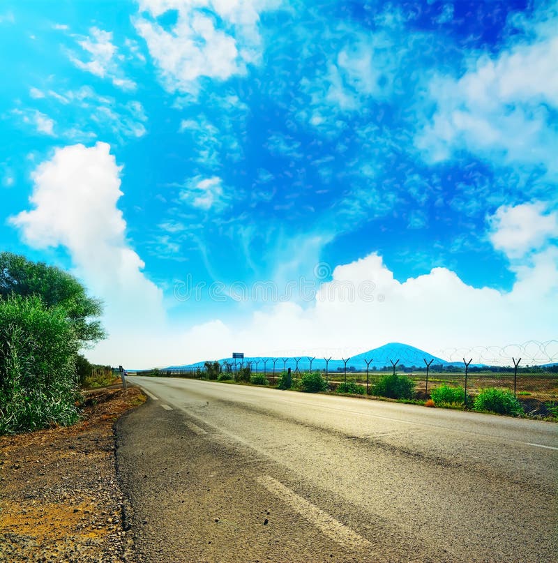 Country road under clouds stock image. Image of roadway - 57697195
