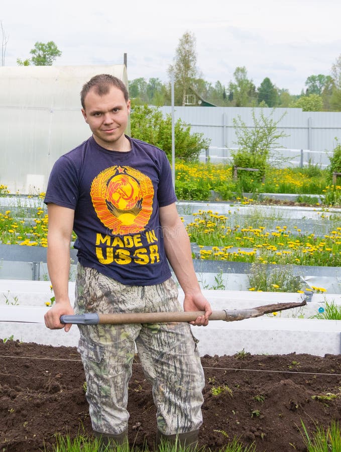 Country of Work. in the Country, a Young Man Cultivates the Land. Stock ...