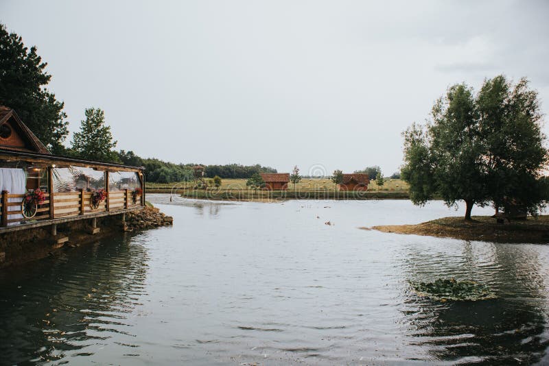 Countryside with Barns by a River on a Cloudy Day Stock Photo - Image ...