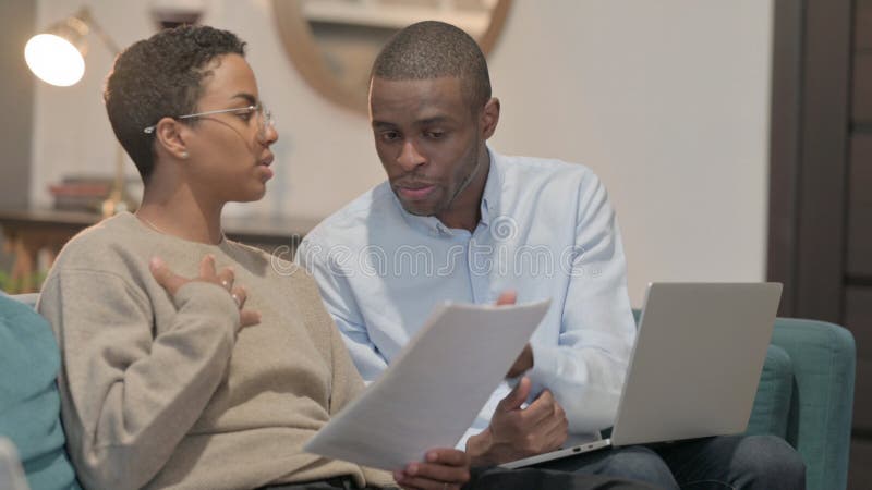Couple Arguing Over Documents while Working Laptop, on Sofa Stock Image ...