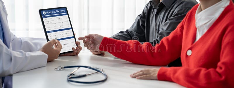 Couple Attend Fertility Consultation With Gynecologist At Hospital