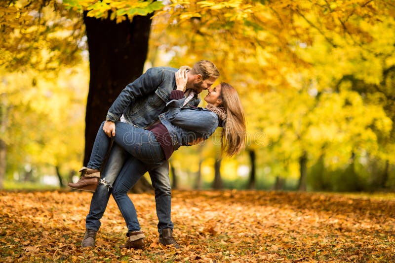 Couple in the autumn park stock photo. Image of autumn - 80223000