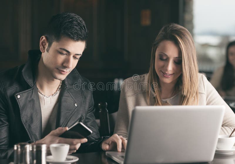 Couple at the Bar Using a Laptop Stock Image - Image of people, mobile ...