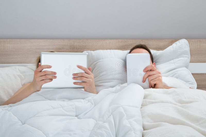 Couple in Bed with Digital Tablets Stock Photo - Image of notebook ...