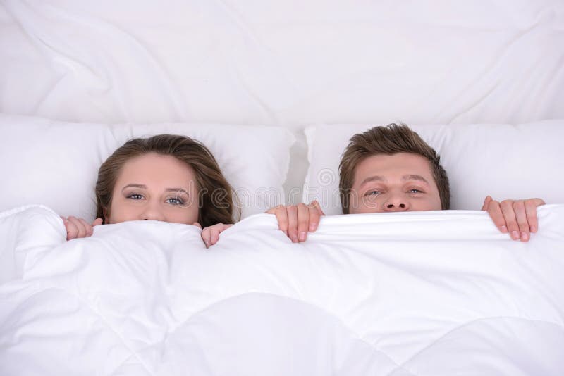 Top View. Calm Young Couple Lies Across Bed Perpendicular To Each Other ...