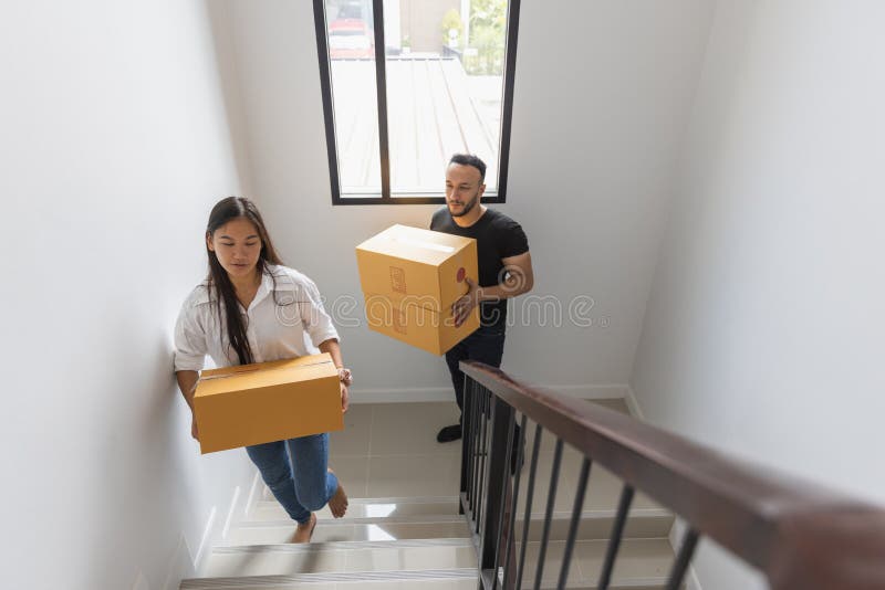 A Couple with a Big Box in Their New Home. Carrying Things into a New ...