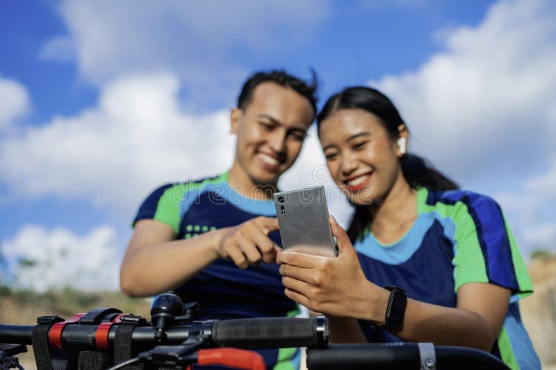 Couple Biker Using Phone for Maps Stock Image - Image of hill, looking ...