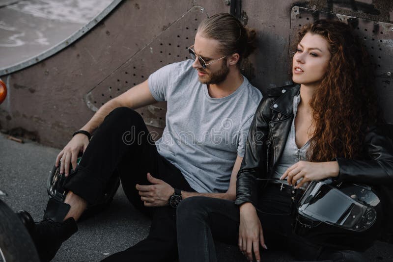 Couple of Bikers Sitting on Asphalt with Helmets Stock Image - Image of ...