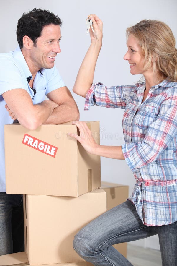 Couple with boxes smiling stock image. Image of male - 35738405
