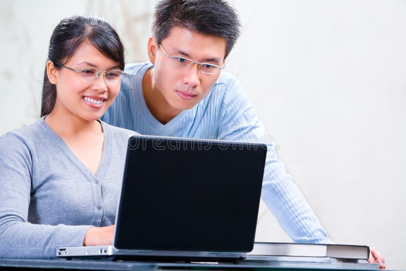 Young Chinese Couple Sitting Using Laptop at Home Stock Photo - Image ...
