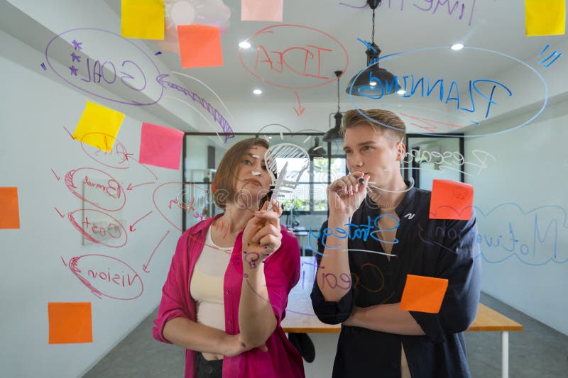 Couple of Business People Brainstorming Idea by Using Sticky Note ...