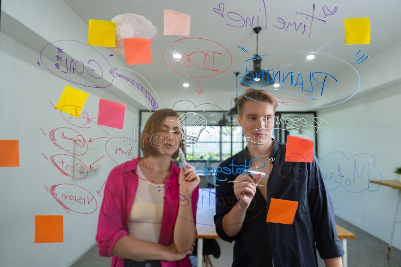Couple of Business People Brainstorming Idea by Using Sticky Note ...