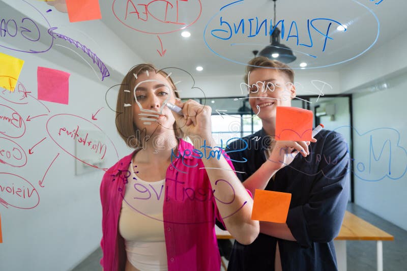 Couple of Business People Brainstorming Idea by Using Sticky Note ...