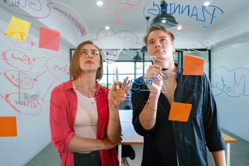 Couple of Business People Brainstorming Idea by Using Sticky Note ...