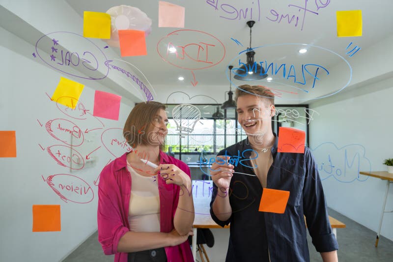 Couple of Business People Brainstorming Idea by Using Sticky Note ...