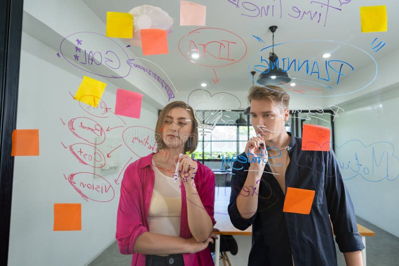 Couple of Business People Brainstorming Idea by Using Sticky Note ...