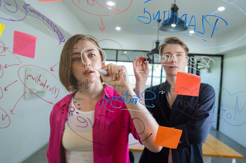 Couple of Business People Brainstorming Idea by Using Sticky Note ...