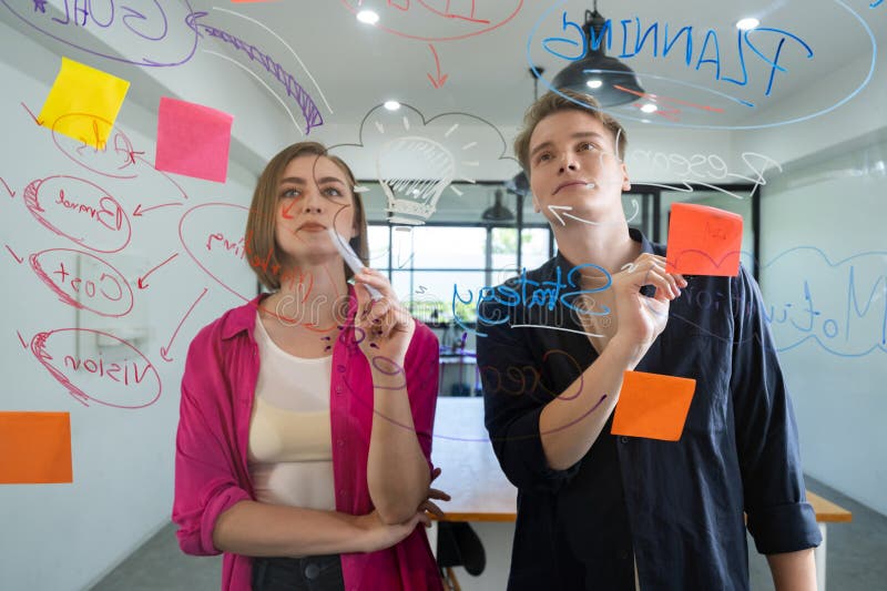 Couple of Business People Brainstorming Idea by Using Sticky Note ...
