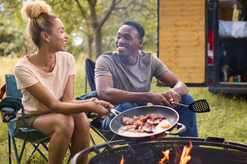 Couple Camping in Countryside with RV Cooking Bacon and Eggs for ...