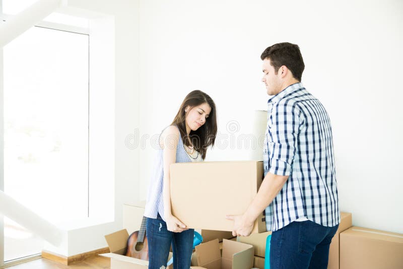 Couple Carrying Moving Boxes Together in New Home Stock Photo - Image ...
