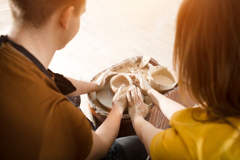 Couple in Casual Clothes and Aprons Making Ceramic Pot on Pottery Wheel ...