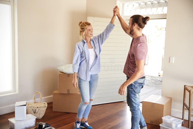 Couple Celebrating in New Home on Moving Day Stock Image - Image of ...